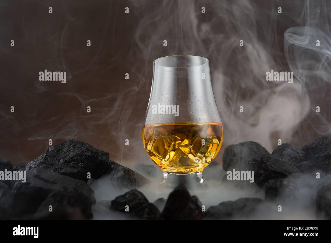 Whisky in a Glencairn Whisky Glass sitting on burning coal, whisky ...
