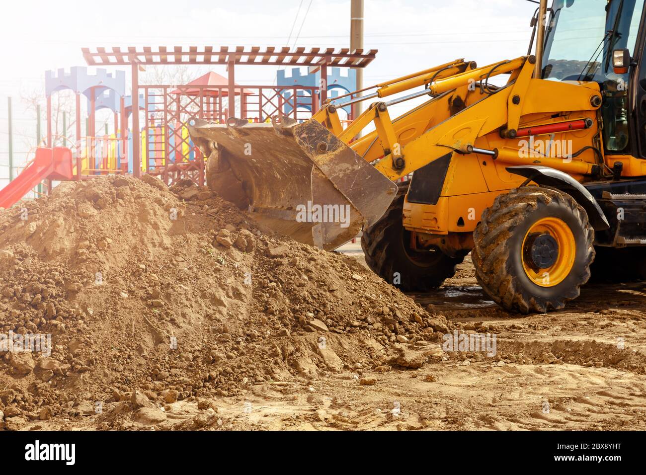 Excavator in sunlight. Digger machine digging and removing earth ...