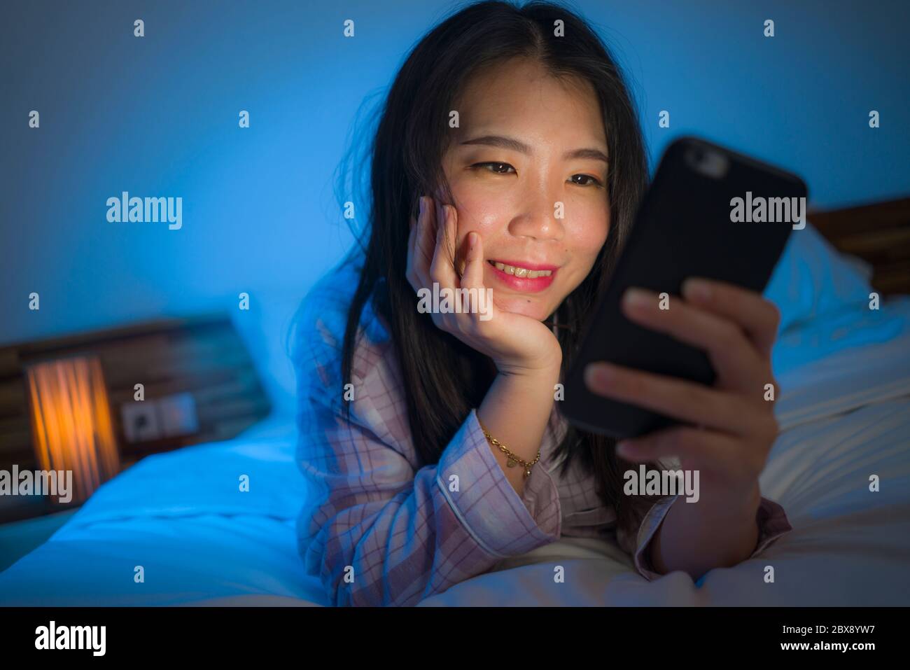 bedtime lifestyle portrait of young beautiful and happy sweet Asian ...