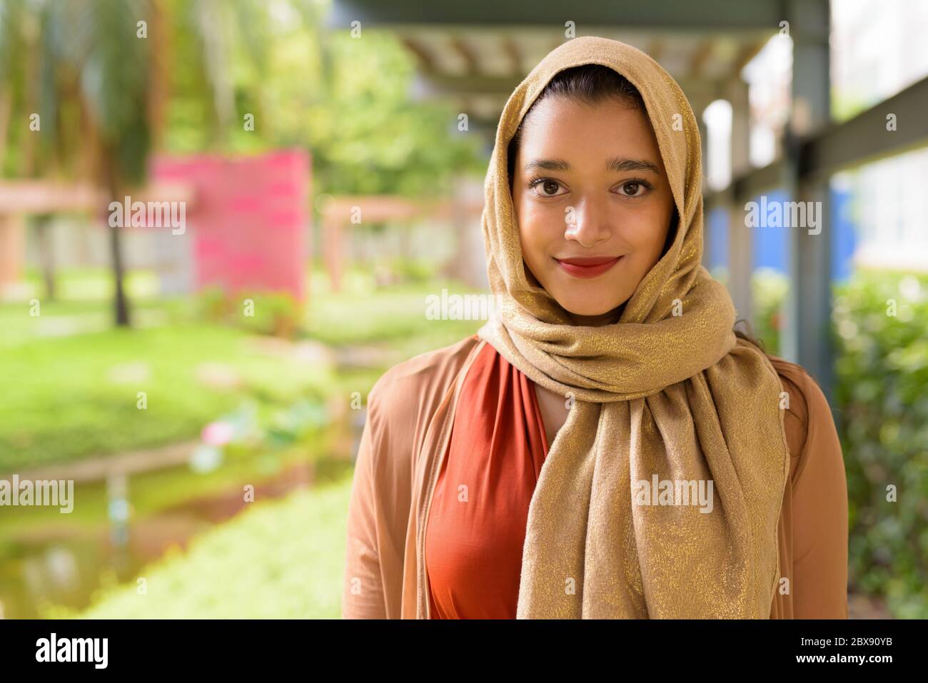 Face of young beautiful Indian Muslim woman at the park outdoors Stock ...