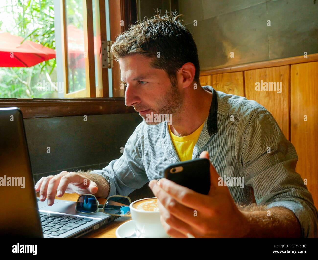 young attractive happy and successful millennial man working from ...