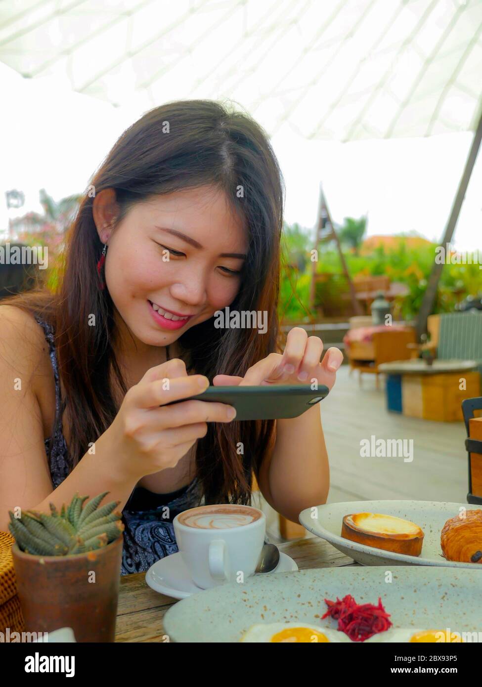 young pretty and happy Asian Korean travel blogger woman taking picture ...
