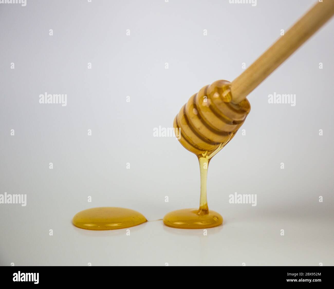 Honey dripping isolated on a white background. Natural remedy and ...