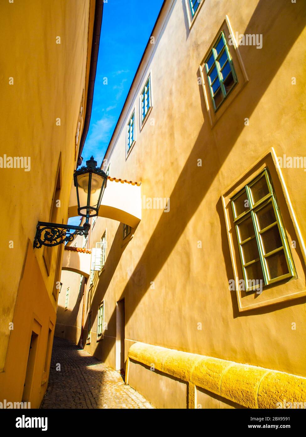 Morning Prague scene. Sunlit and long shadows on the wall with gas ...