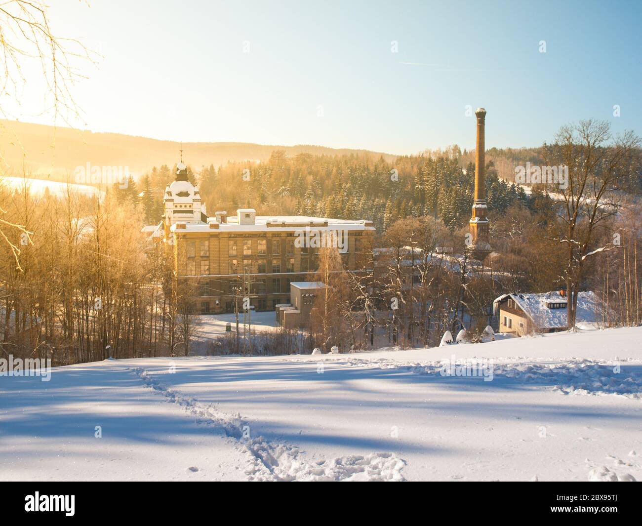 Old textile factory called Klaster, Monastery, with high chimney in ...