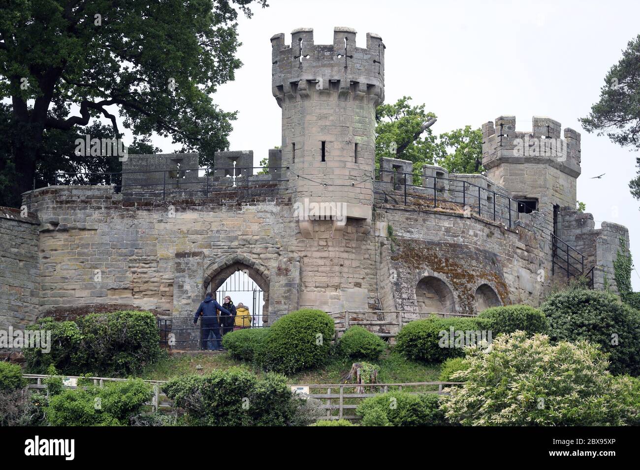 People on a walk during a visit to Warwick Castle, which is one of the ...