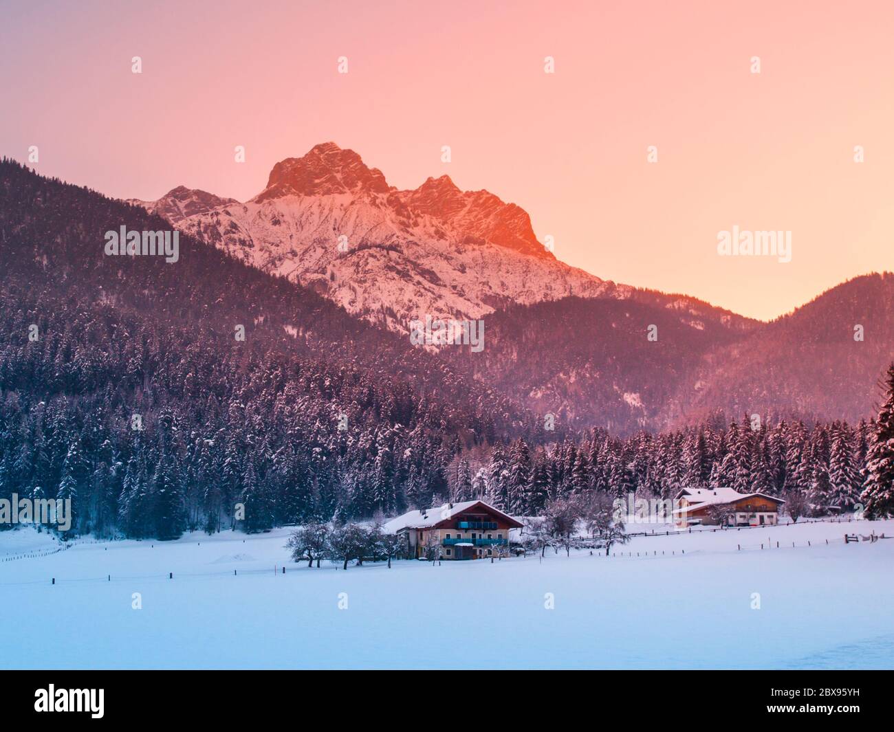 Mountain illuminated by sunrise in winter Alps. Freezy morning alpine ...