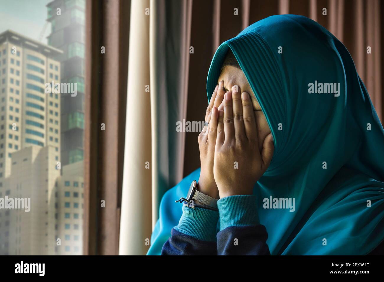 lifestyle portrait of young sad and depressed Muslim woman in Islam ...