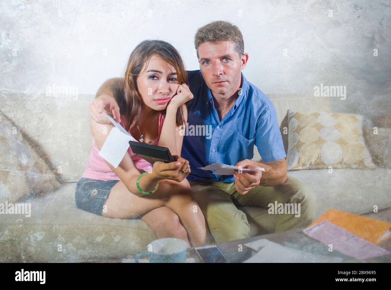 young attractive sad and worried couple accounting together in ...