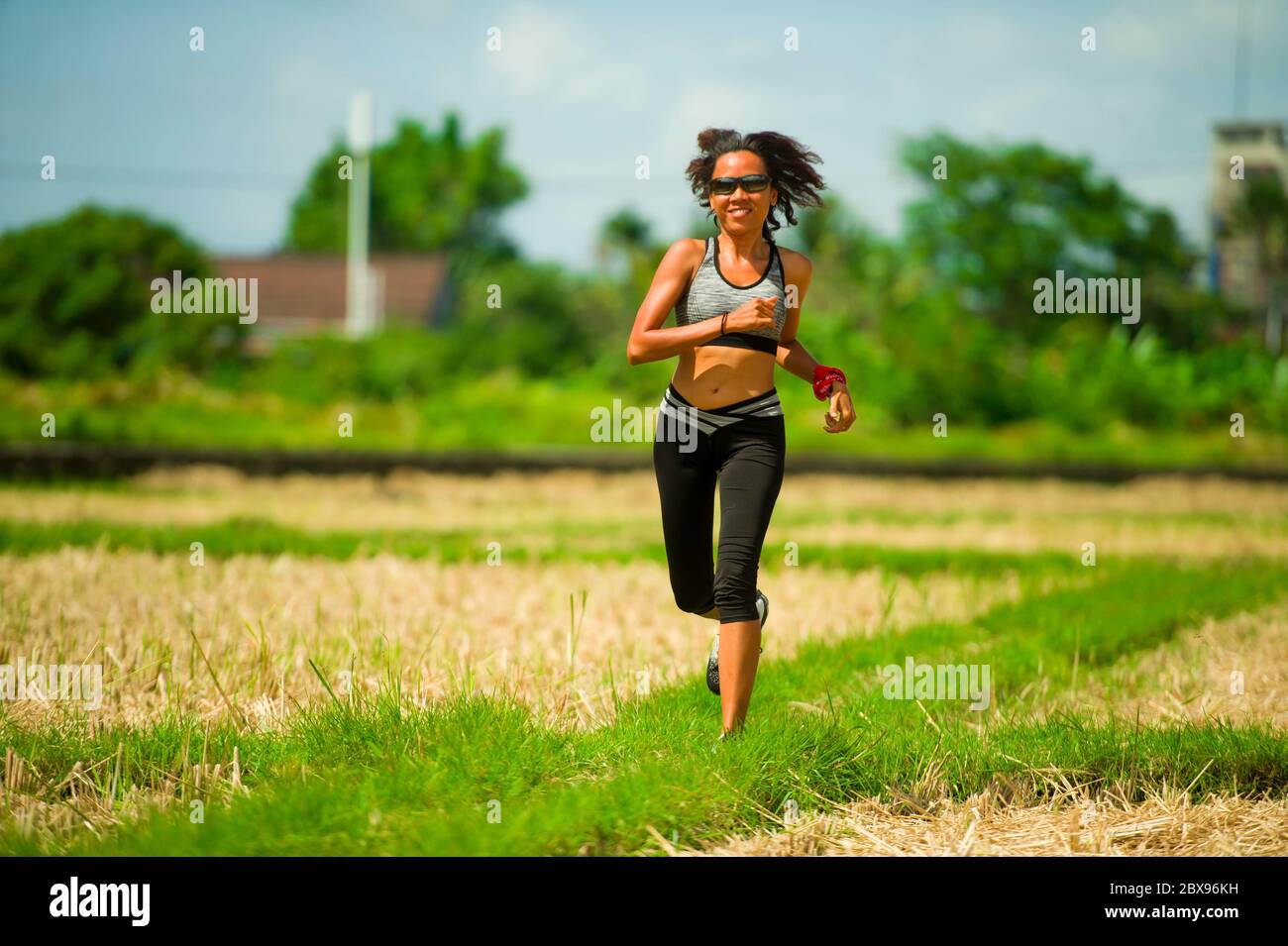 healthy lifestyle portrait of young happy and fit Asian Chinese runner ...