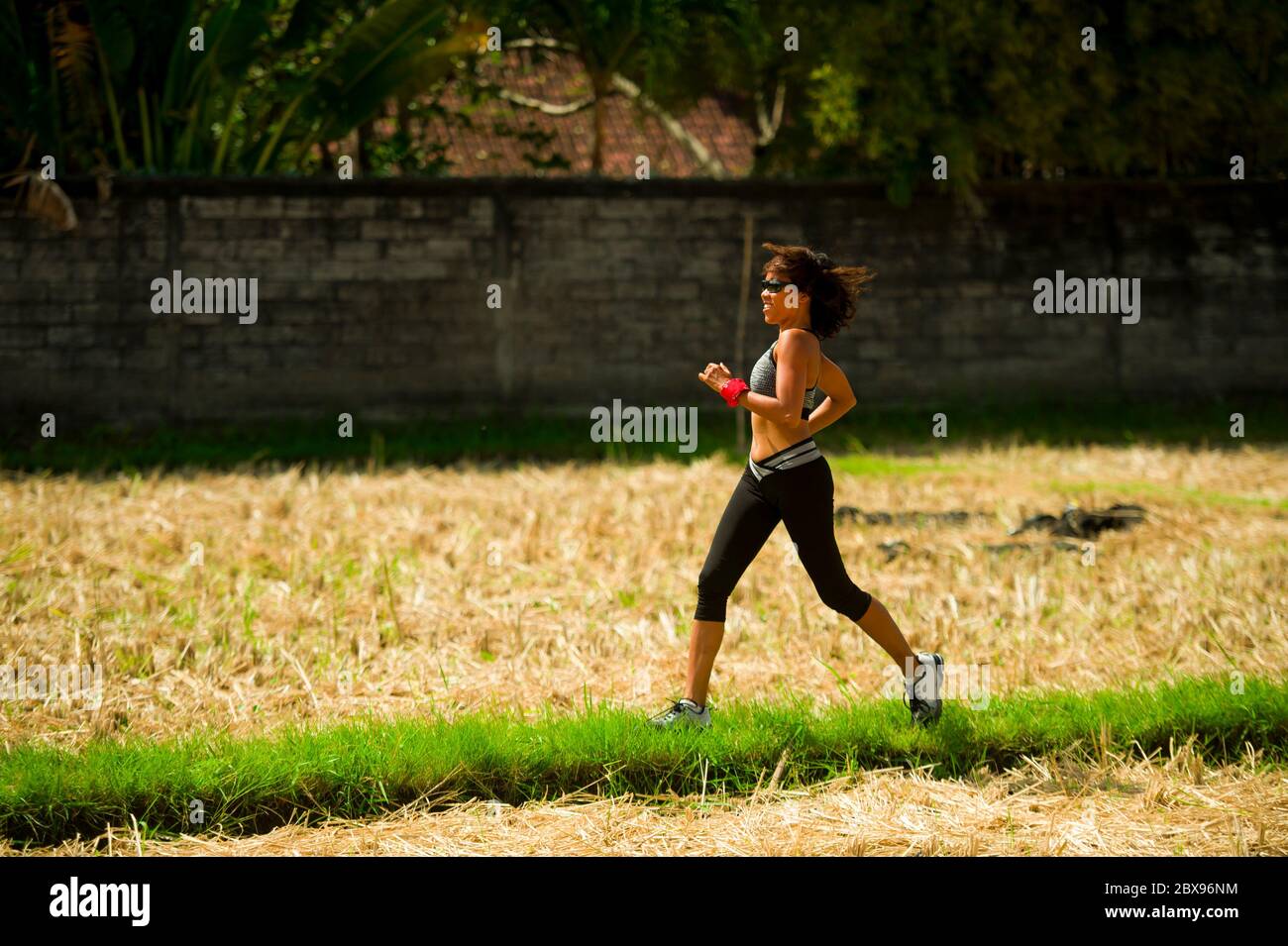 healthy lifestyle portrait of young happy and fit Asian Chinese runner ...
