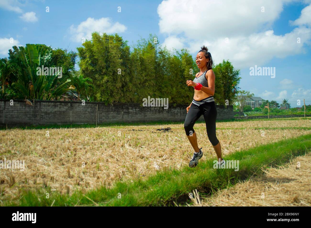 healthy lifestyle portrait of young happy and fit Asian Chinese runner ...
