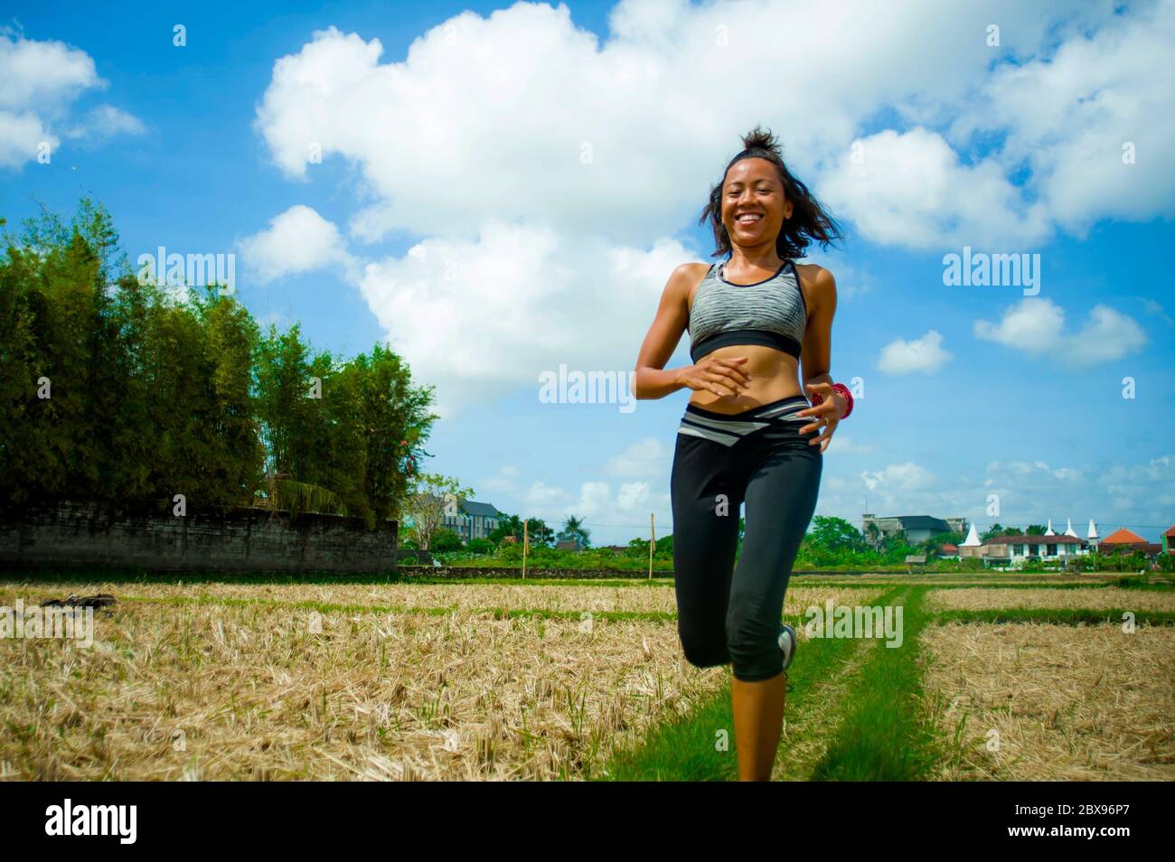 healthy lifestyle portrait of young happy and fit Asian Chinese runner ...