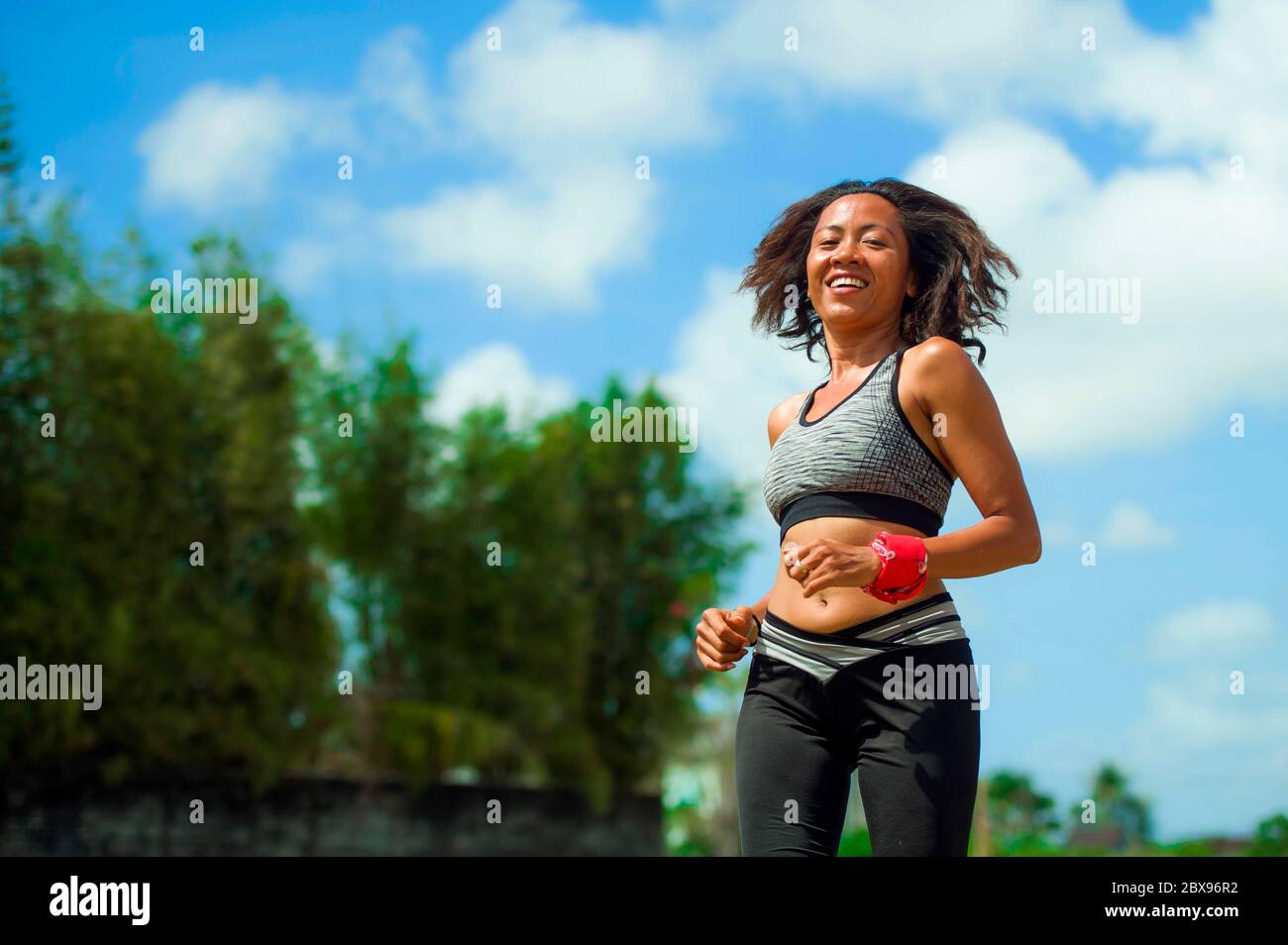 healthy lifestyle portrait of young happy and fit Asian Chinese runner ...