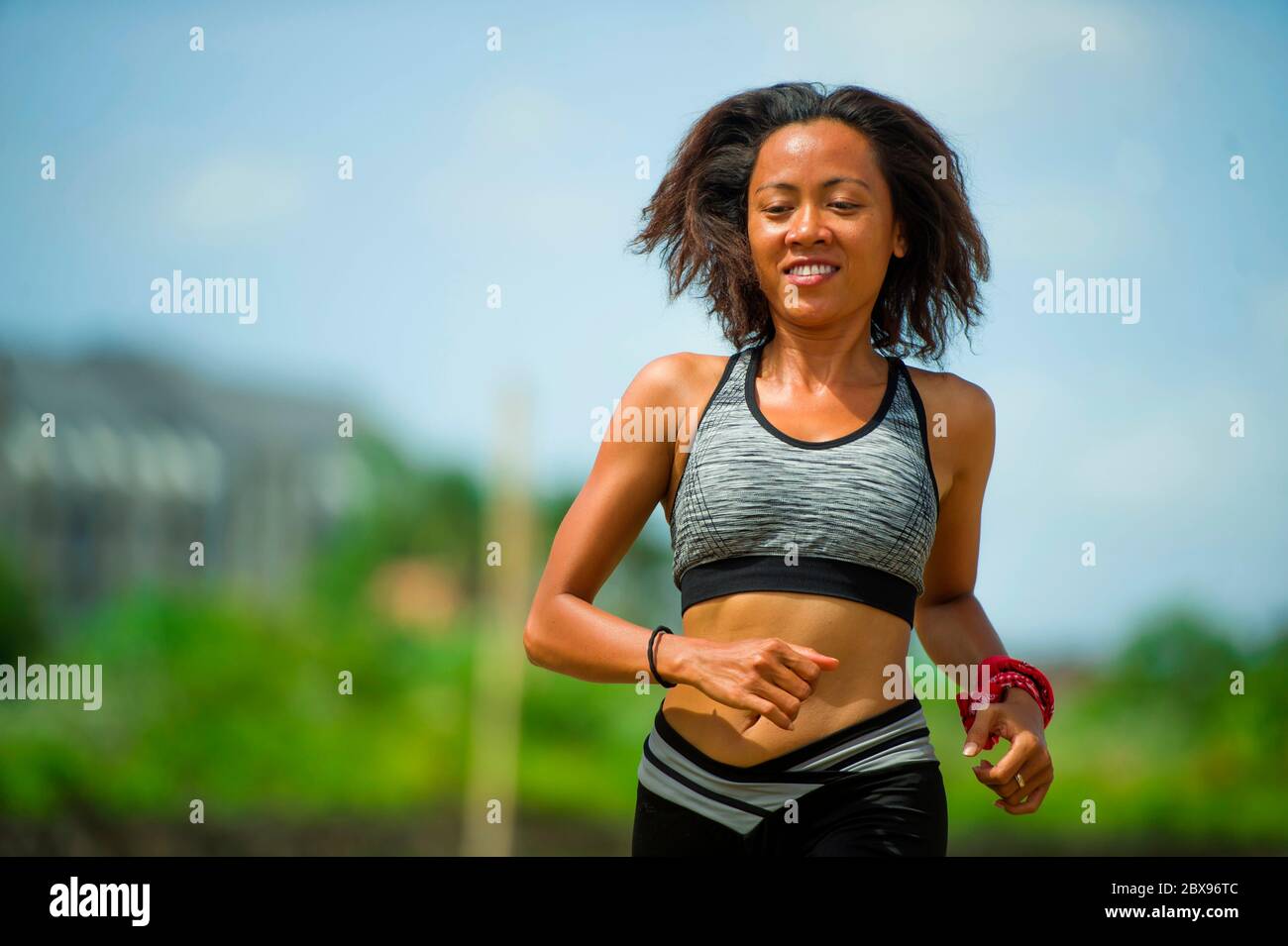 healthy lifestyle portrait of young happy and fit Asian Chinese runner ...