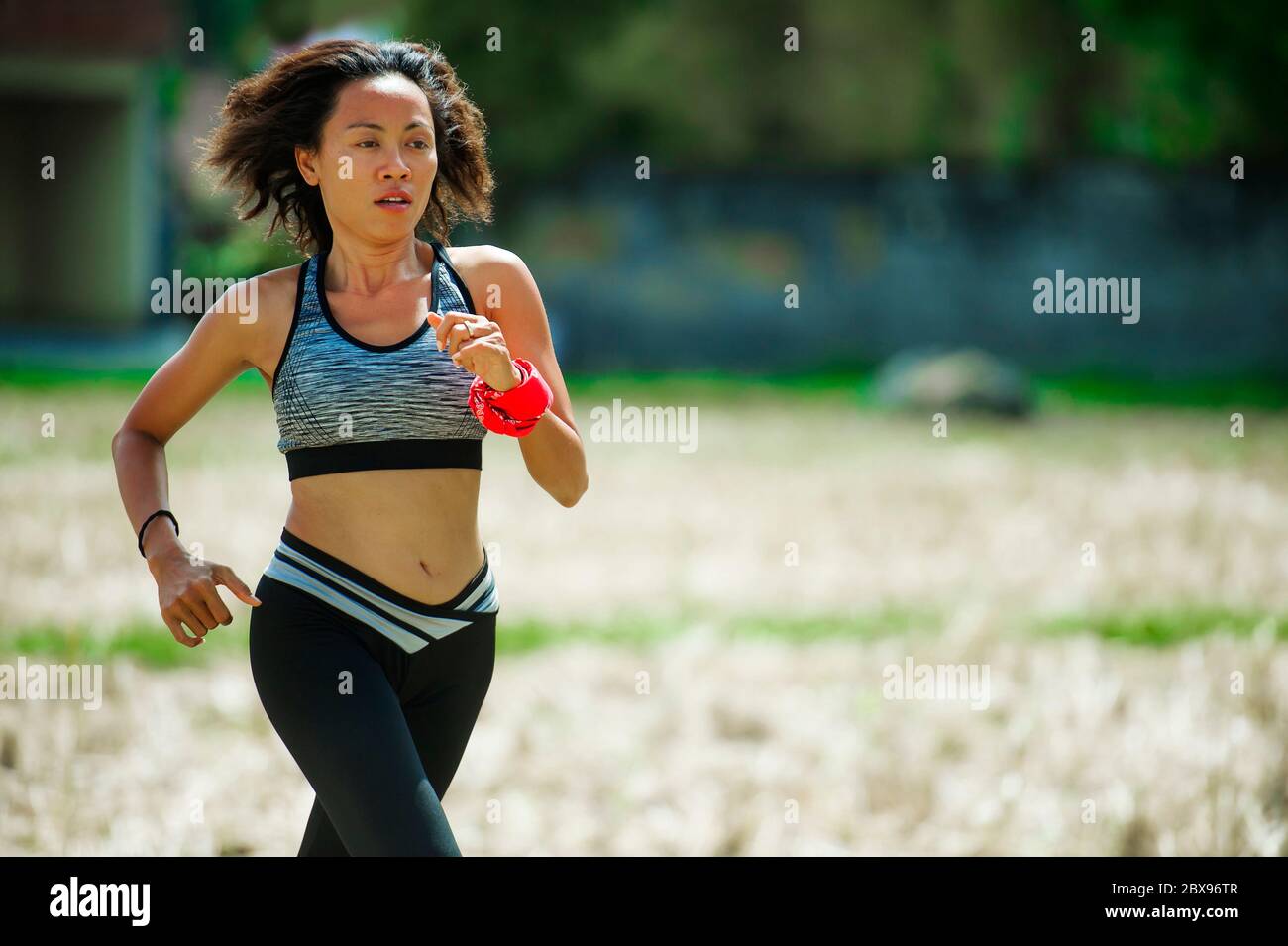 healthy lifestyle portrait of young happy and fit Asian Chinese runner ...