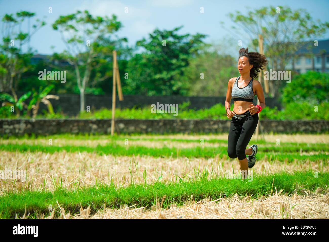 healthy lifestyle portrait of young happy and fit Asian Chinese runner ...