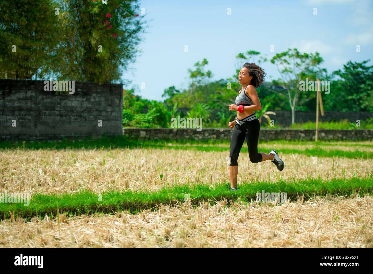 healthy lifestyle portrait of young happy and fit Asian Chinese runner ...