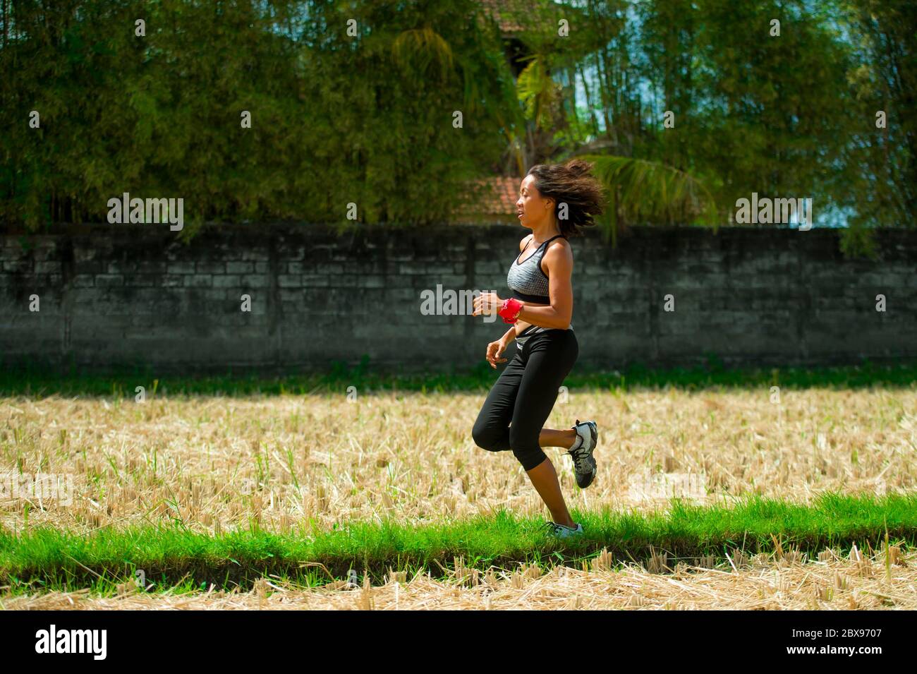 healthy lifestyle portrait of young happy and fit Asian Chinese runner ...