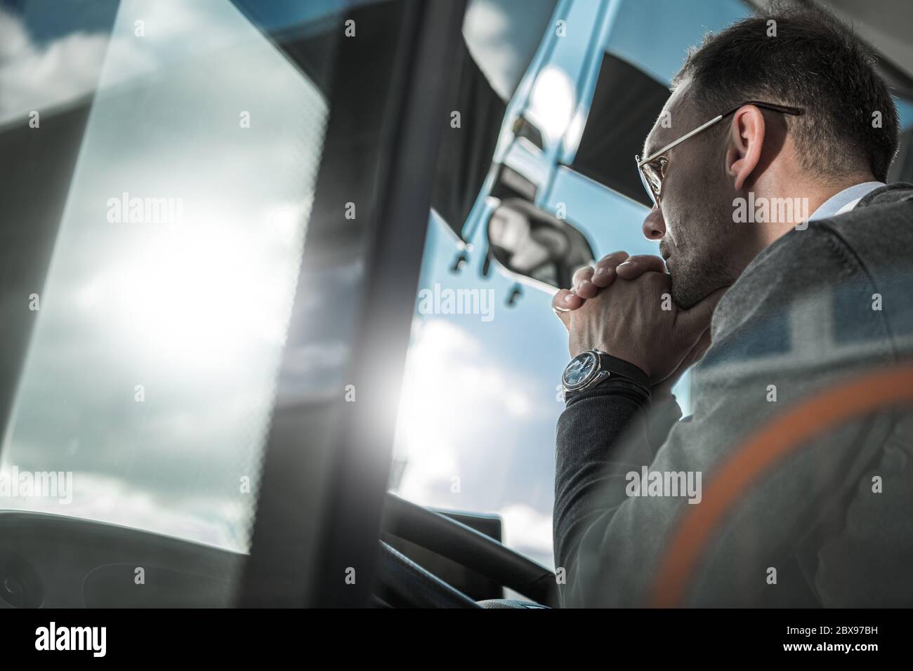 Confused and Pensive Bus Coach Driver Behind Vehicle Wheel Thinking ...