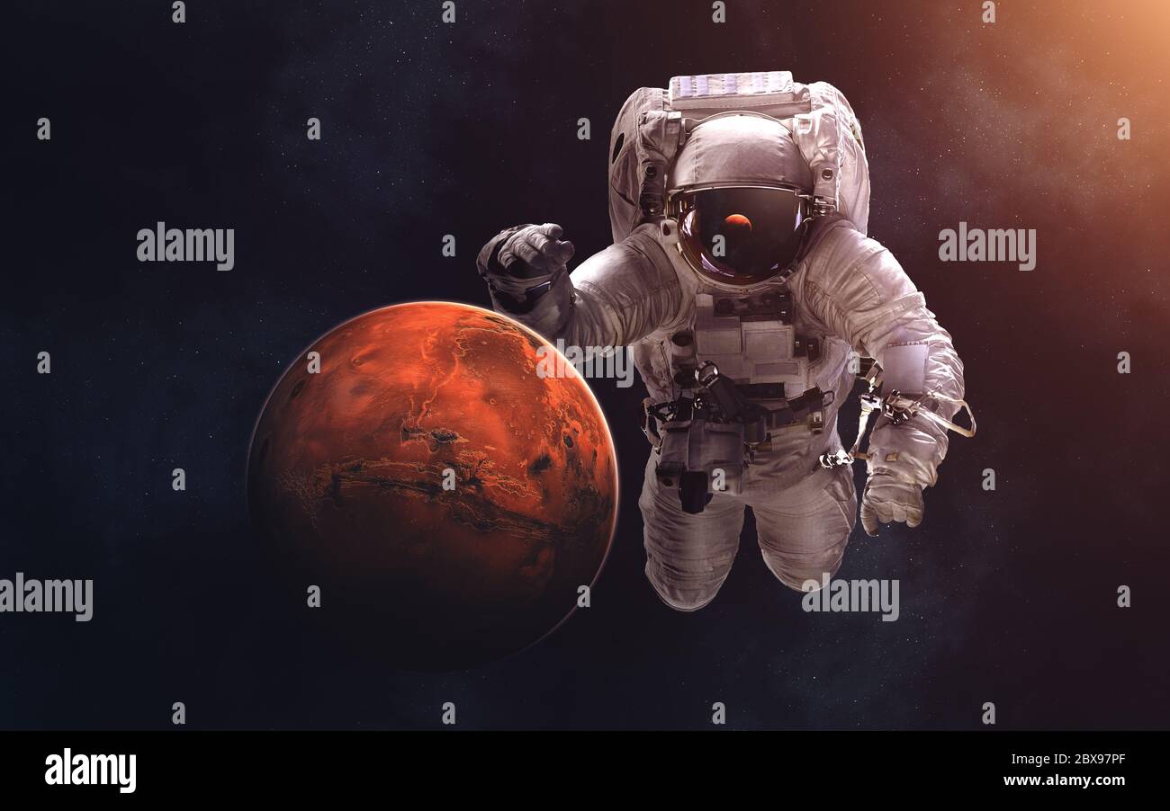 Mars and giant astronaut. Solar system Stock Photo - Alamy