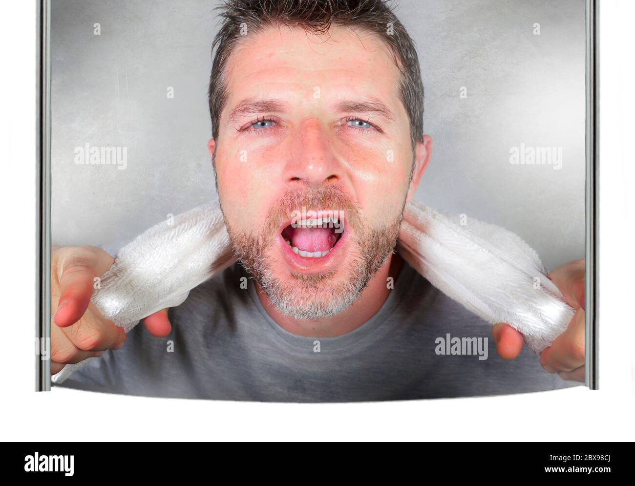 young happy and attractive man using towel drying face after washing ...