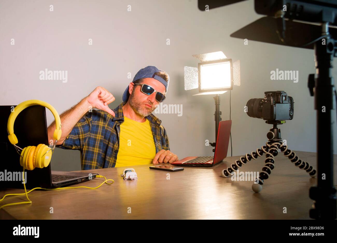 young attractive technology geek man networking with laptop computer ...