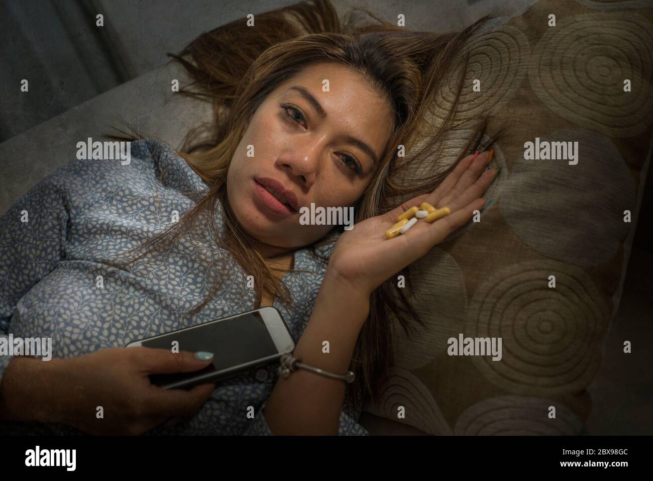 dramatic grunge portrait of young attractive depressed and helpless ...