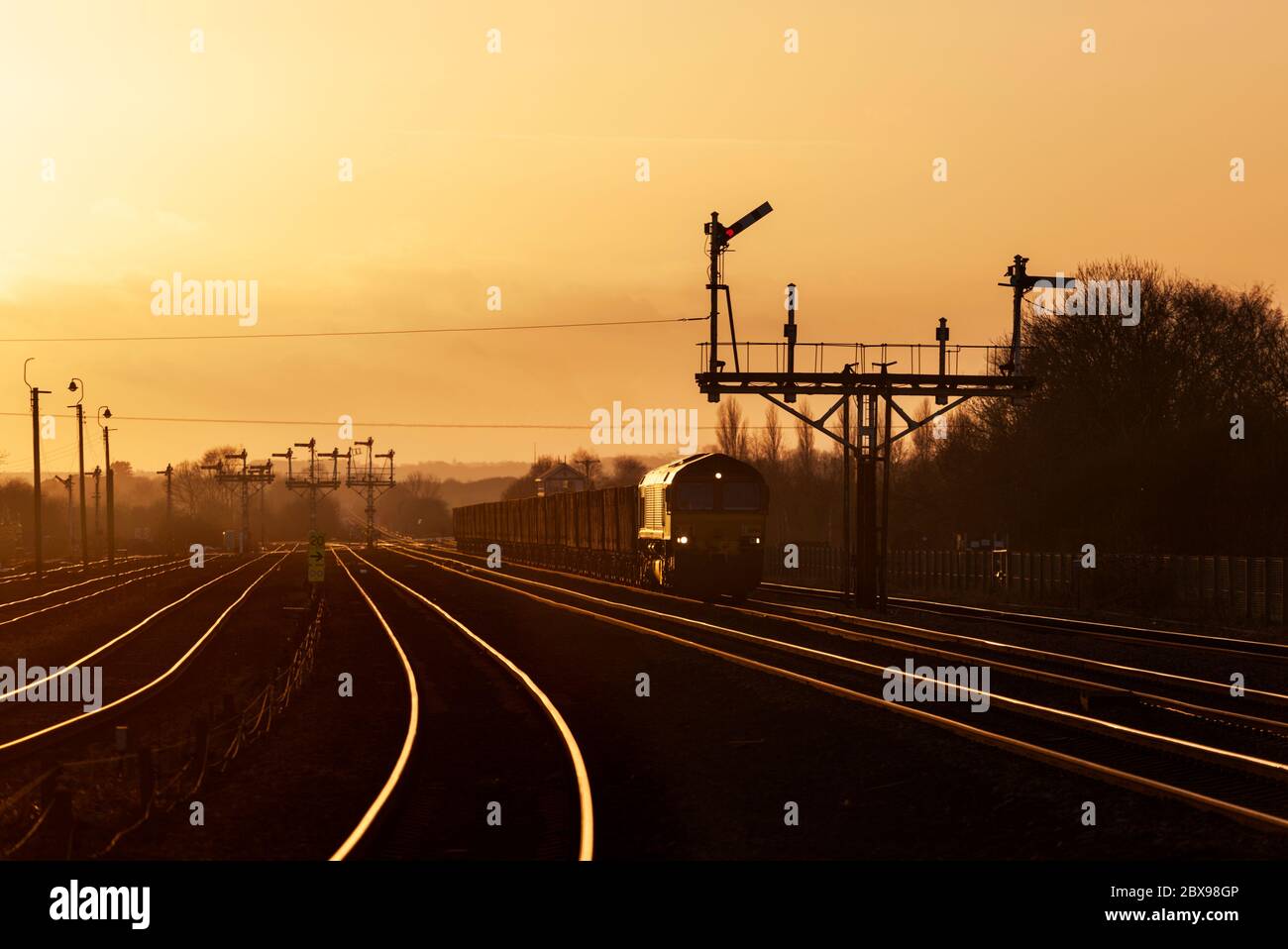DB Cargo Rail UK class 66 locomotive hauling a freight train passing ...