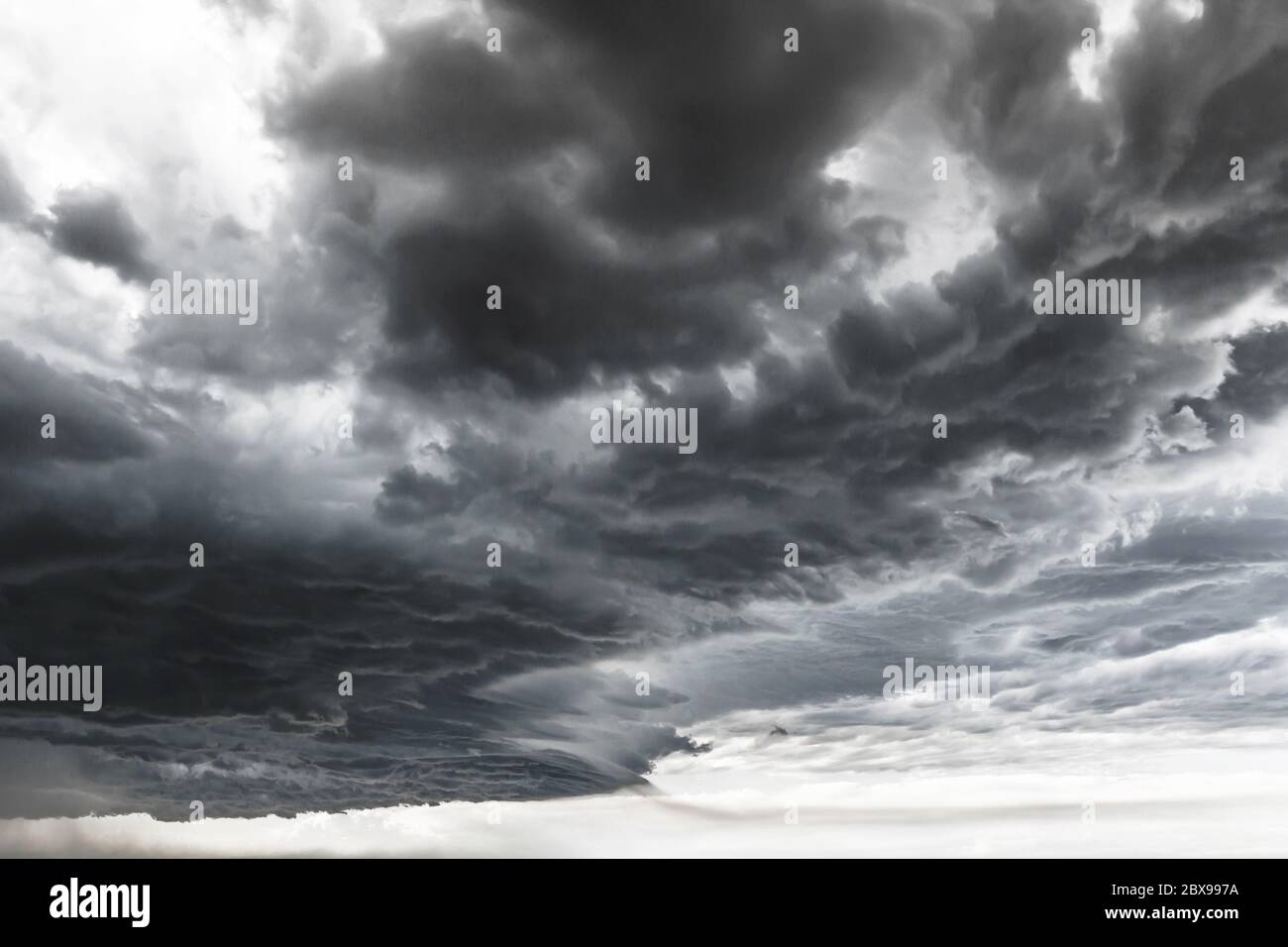 Supercell thunderstorm. Dramatic black clouds and motion. Dark sky with ...