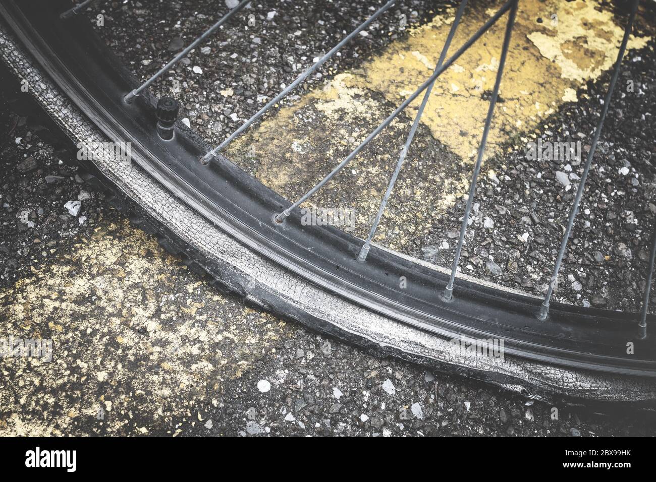 Closeup view of bicycle flat tire on pavement. Flat tire bicycle. Bike ...