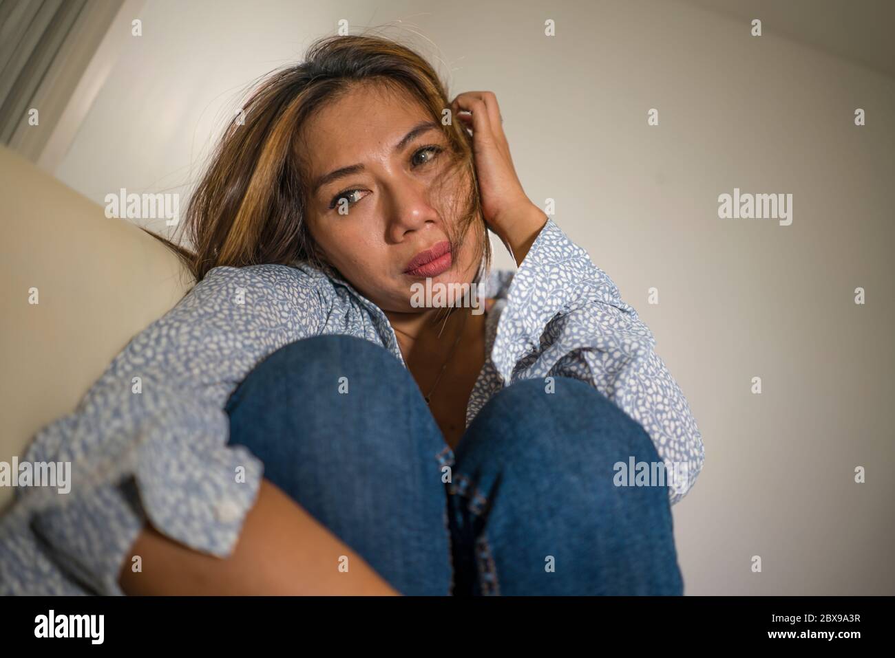dramatic lifestyle portrait of young beautiful sad and depressed woman ...
