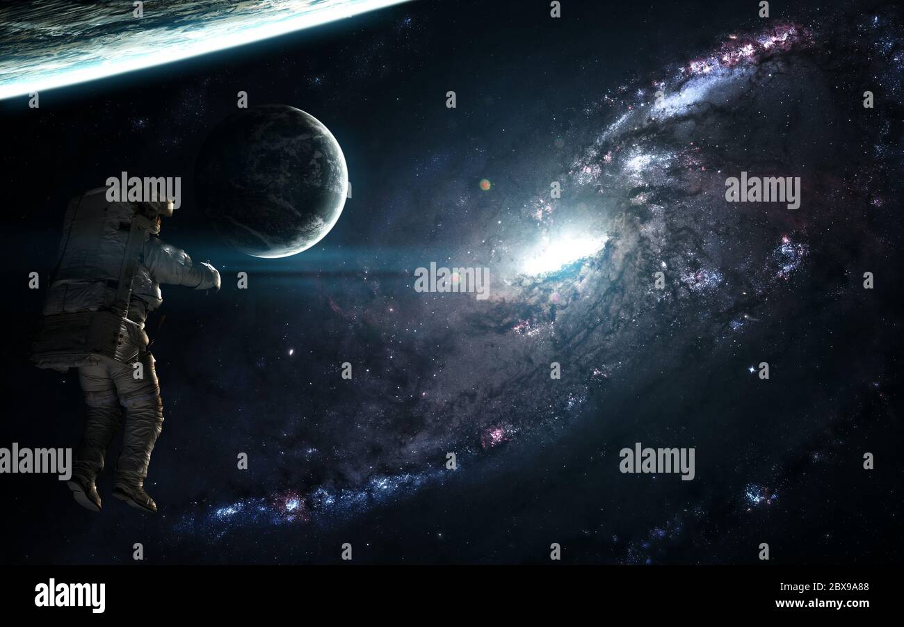 Blue galaxy, astronaut and exoplanets in deep space Stock Photo - Alamy