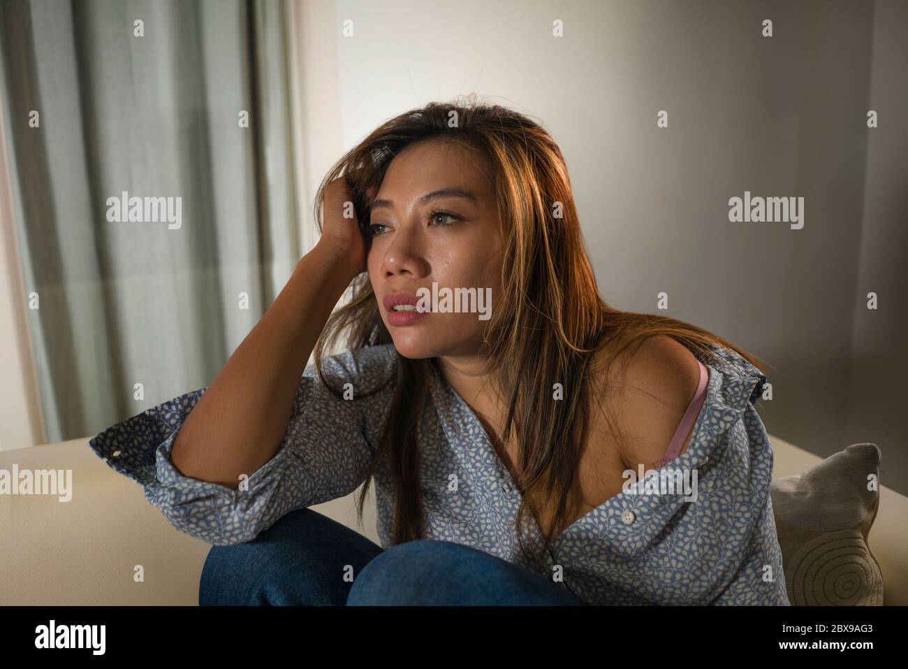 dramatic lifestyle portrait of young beautiful sad and depressed woman ...