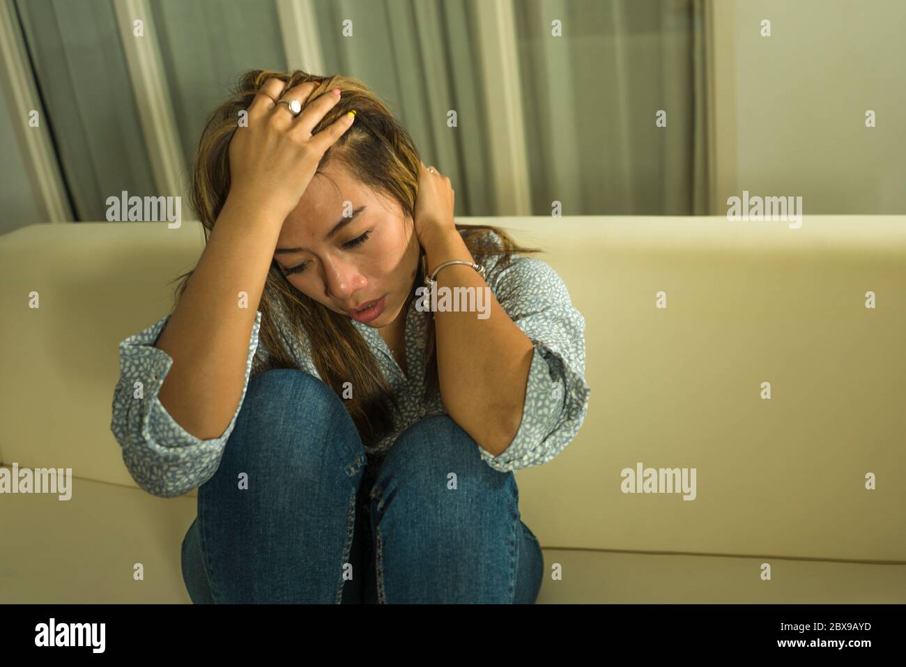 dramatic lifestyle portrait of young beautiful sad and depressed woman ...