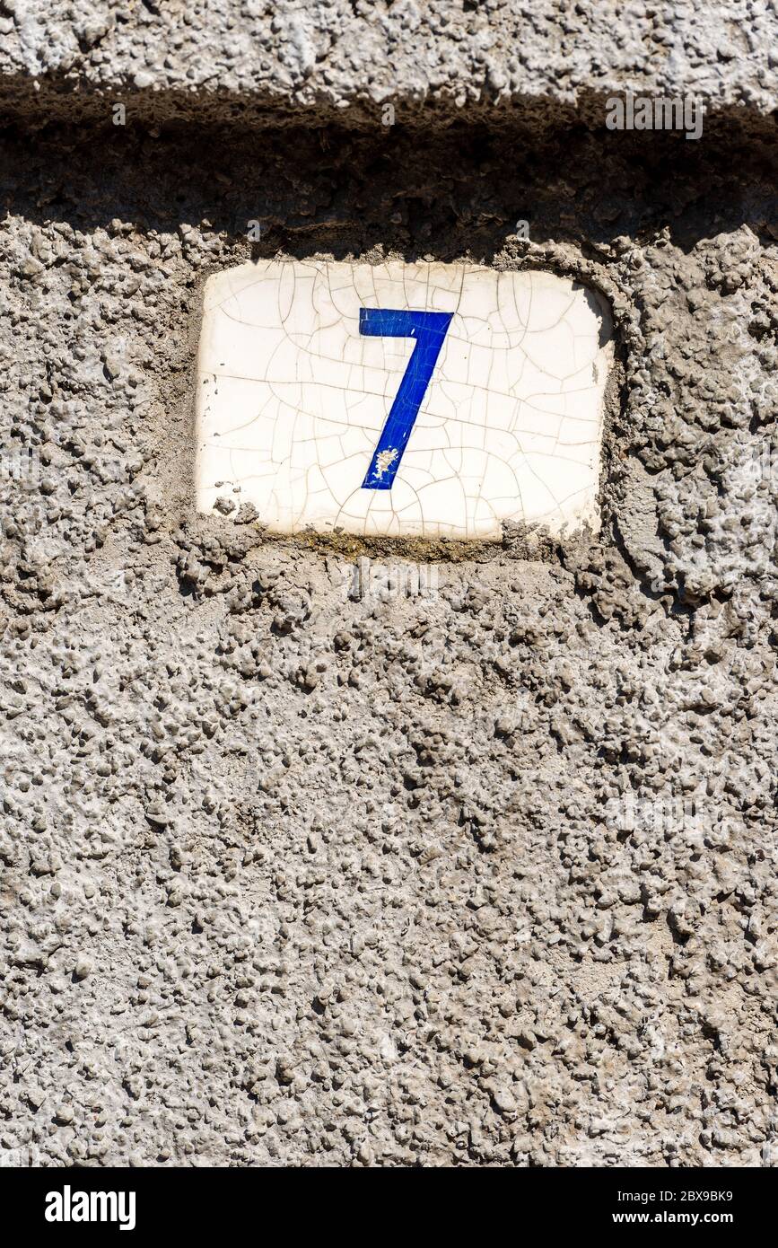 Old house number seven on the wall in a small village. Liguria, Italy ...