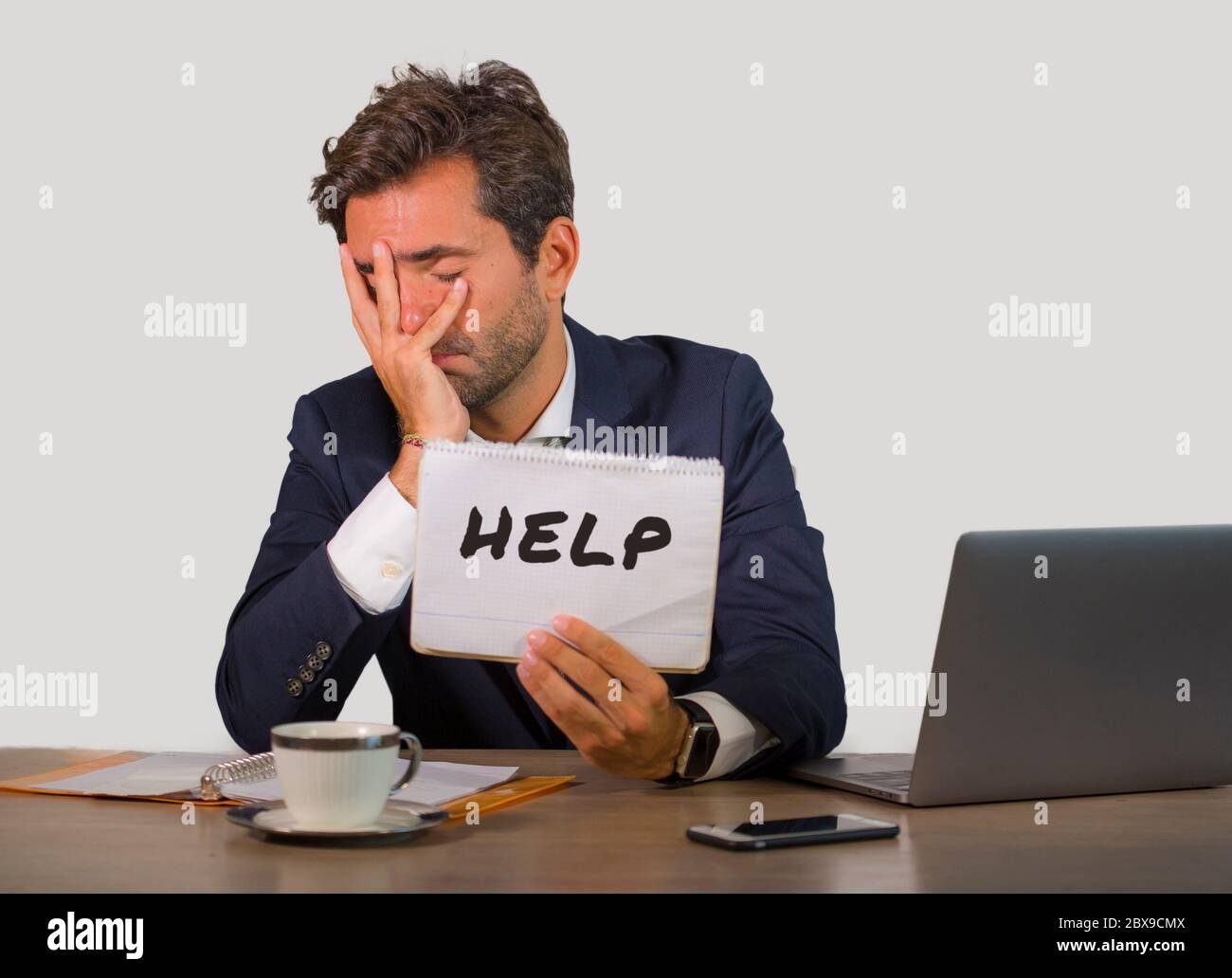 young attractive sad and depressed business man working at office ...