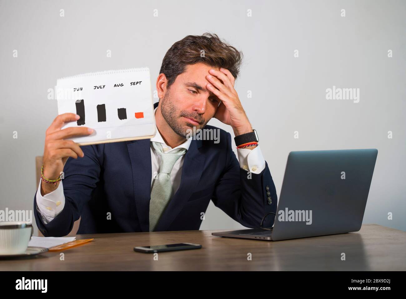 young attractive sad and depressed businessman working in stress at ...