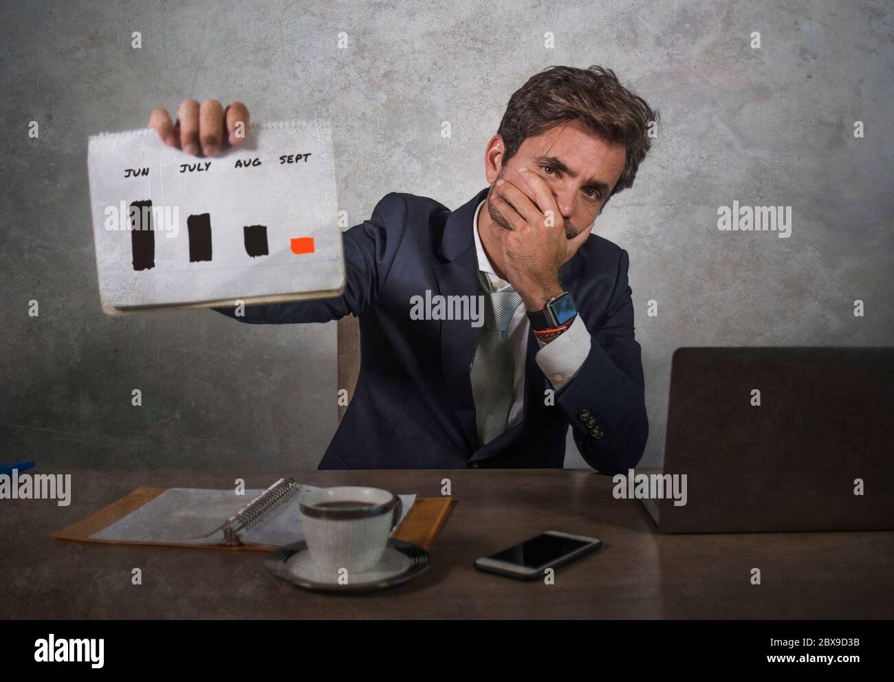 young attractive sad and depressed businessman working in stress at ...