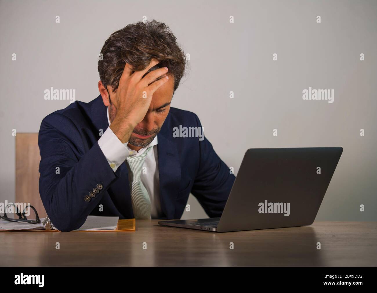 young sad and depressed business man working overwhelmed and frustrated ...