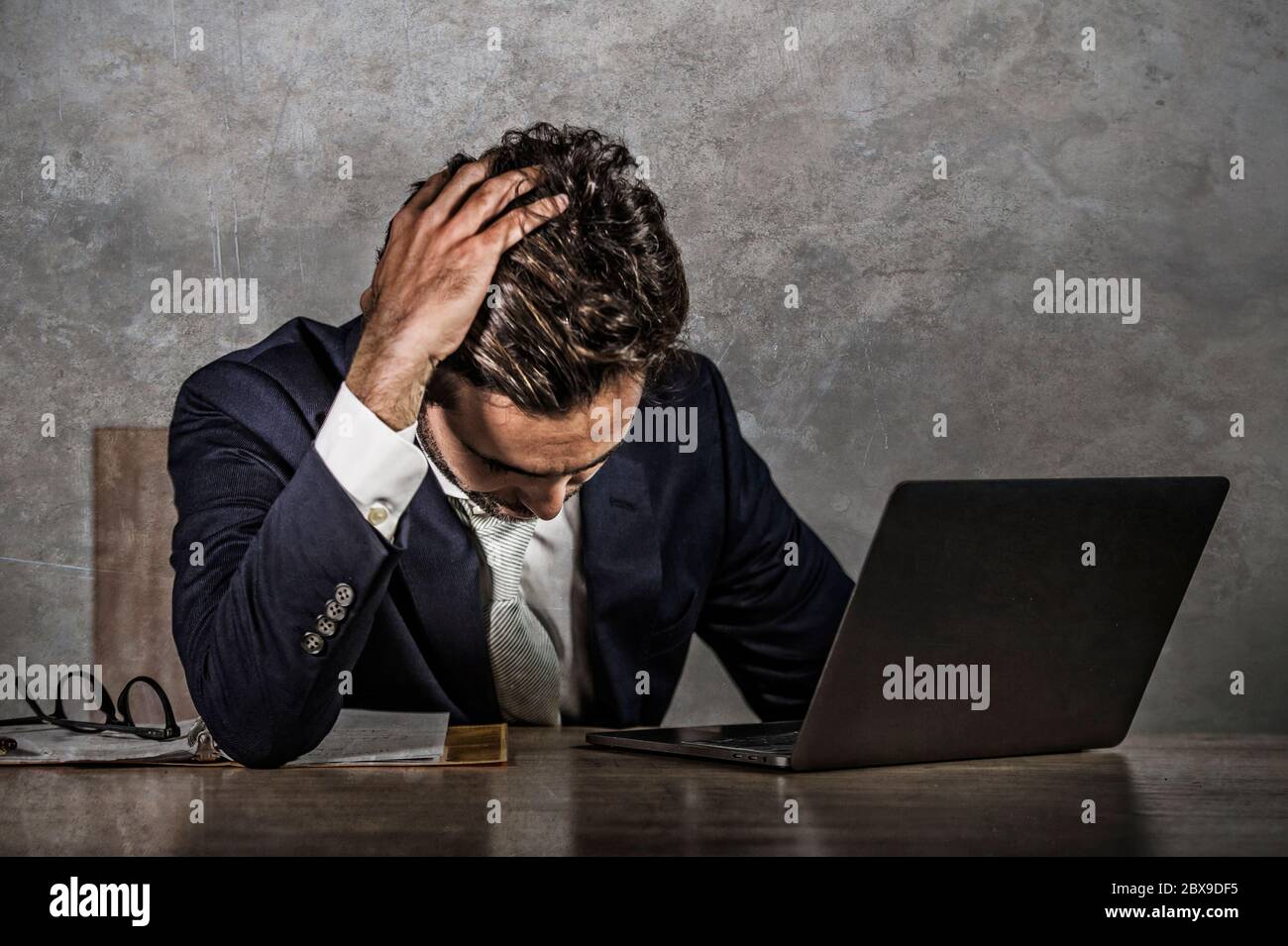 young sad and depressed business man working overwhelmed and frustrated ...