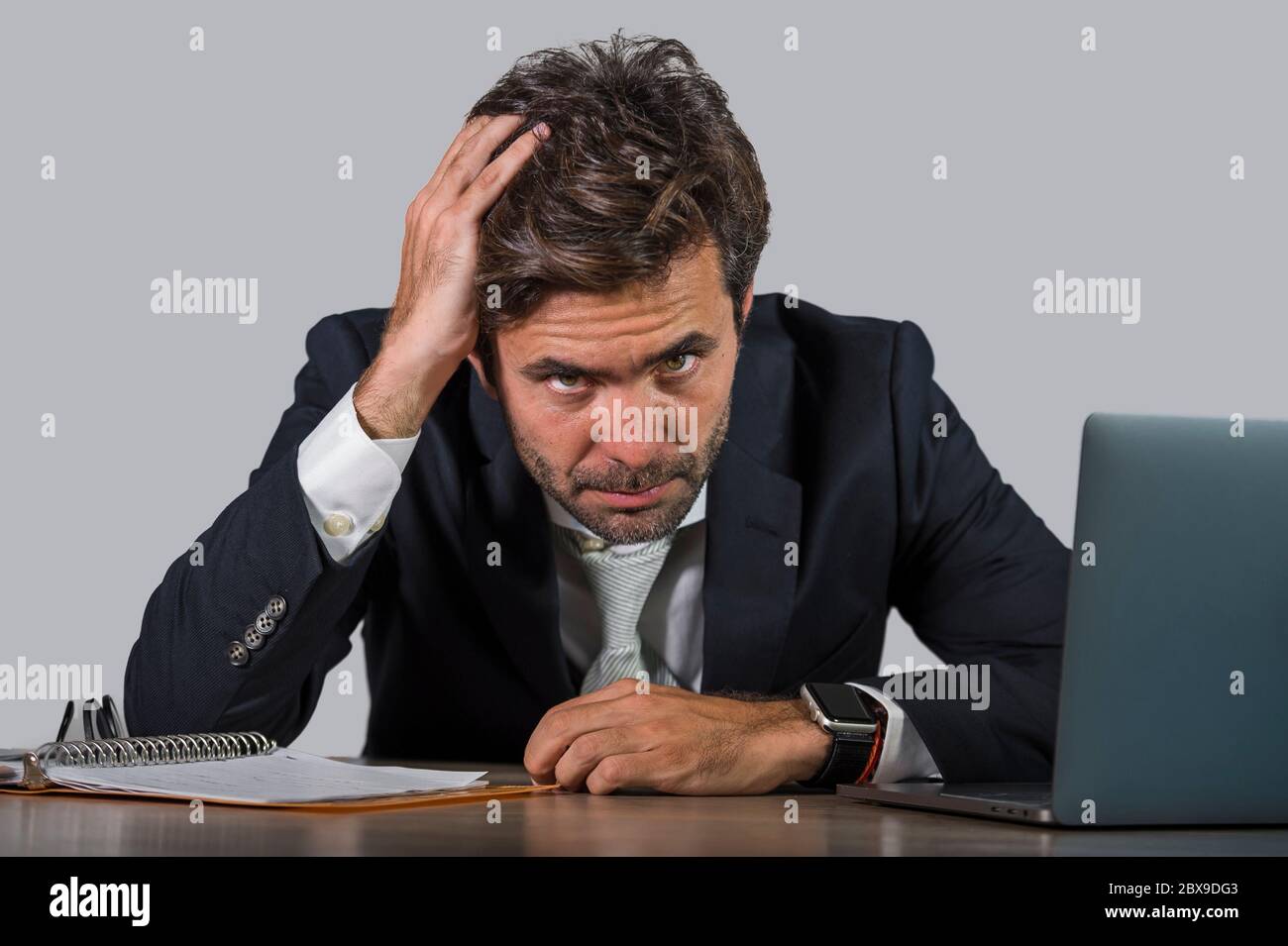 young sad and depressed business man working overwhelmed and frustrated ...