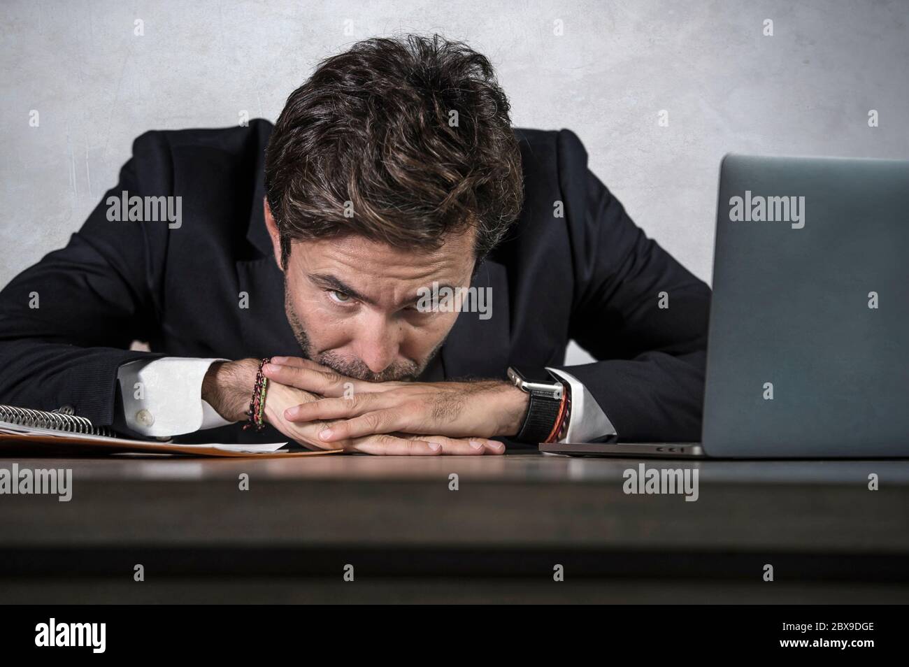 young sad and depressed business man working overwhelmed and frustrated ...