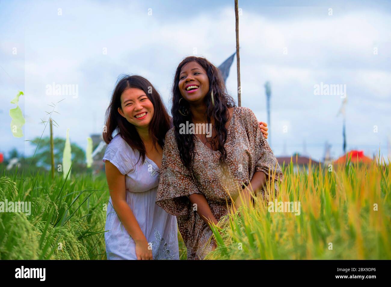 Asian Chinese girl and black Afro American woman exploring together ...