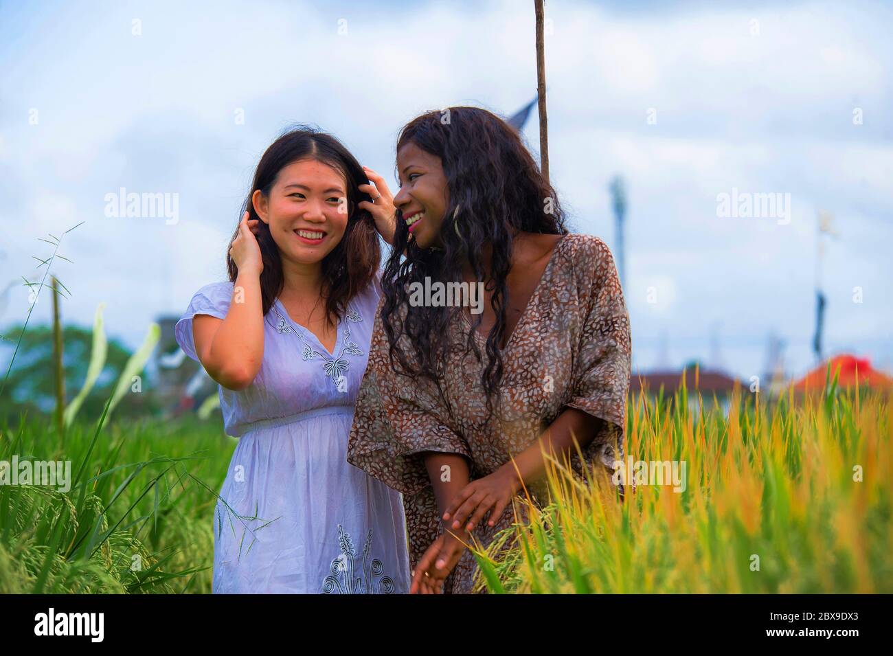 Asian Korean girl and black Afro American woman exploring together ...