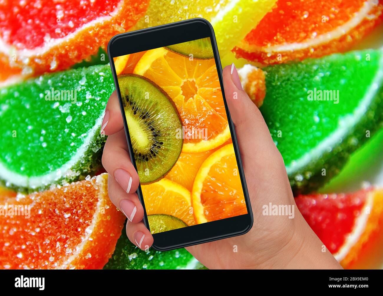 conceptual healthy nutrition and fresh fruits versus sweet citrus candy ...