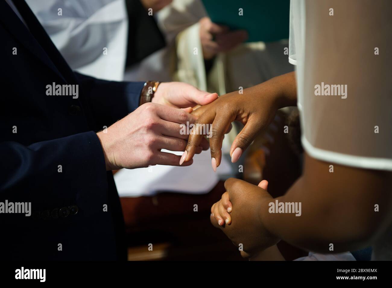 White skin man and black skin woman are getting married in a church ...