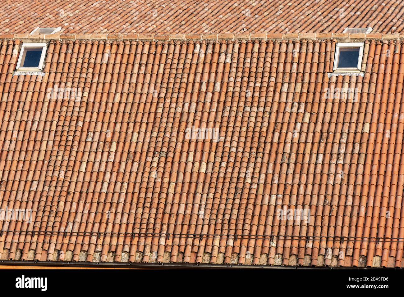 Pantiles. Closeup of an old house roof with tiles made from clay (Coppo ...