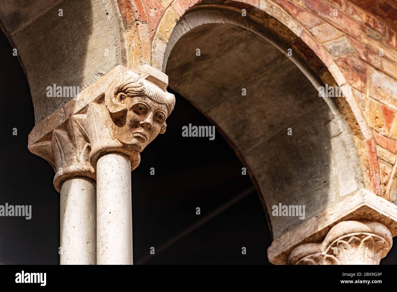Ancient columns with capitals in the shape of a human head, cloister of ...