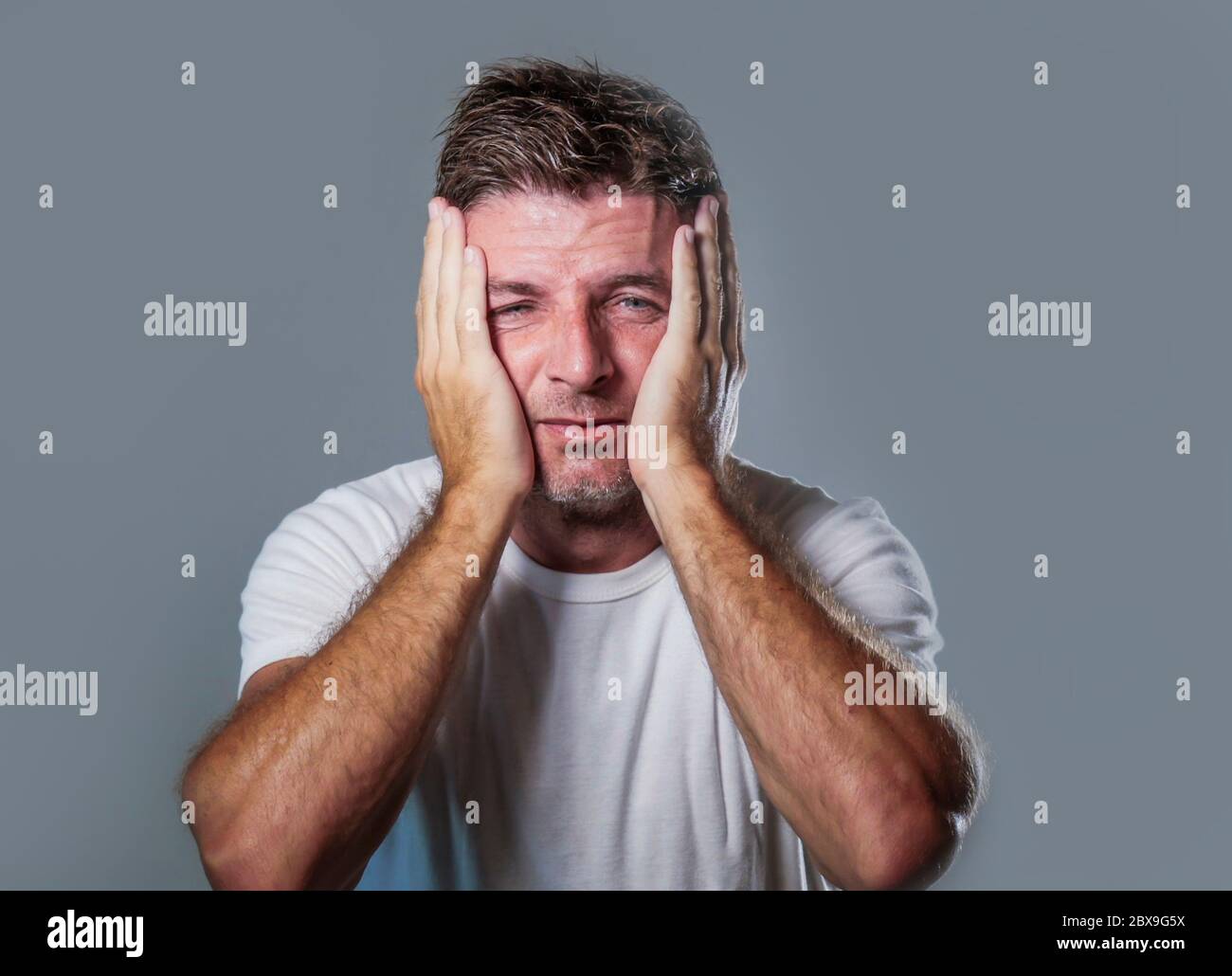 portrait of sad and depressed man with hands on face looking desperate ...